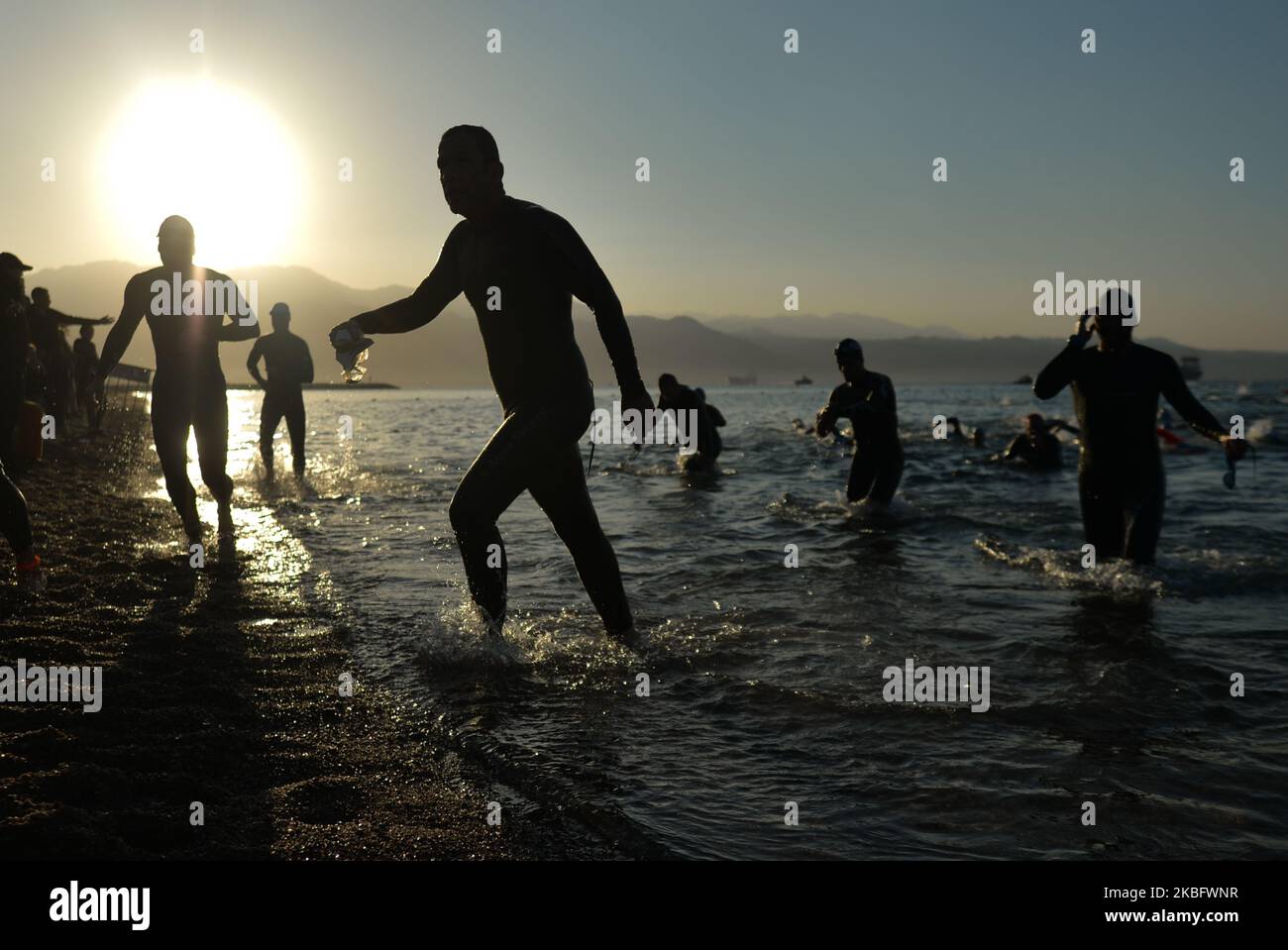 Athletes finishing their swim in the Red Sea during a full Ironman ...