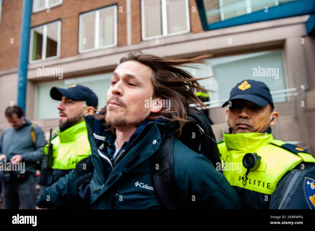 An XR activist is being arrested by the police during an action against ...