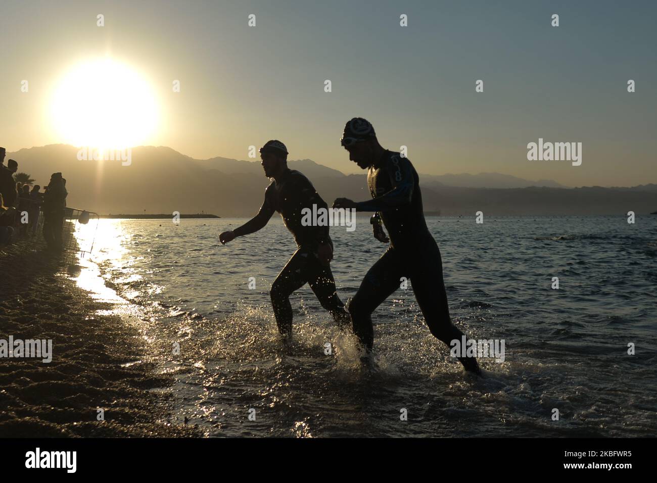 Athletes finishing their swim in the Red Sea during a full Ironman ...