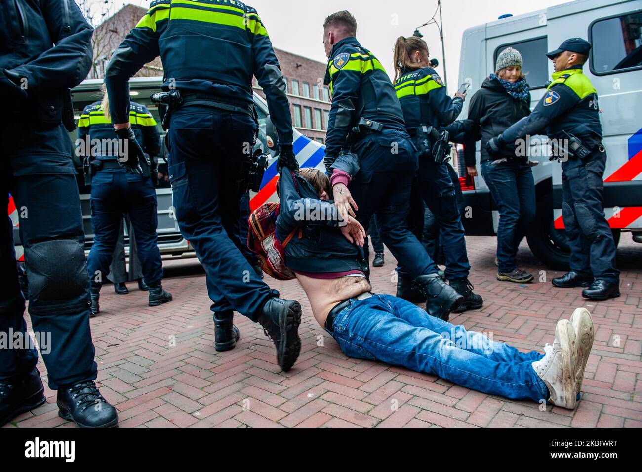 An XR activist is being arrested by the police during an action against ...
