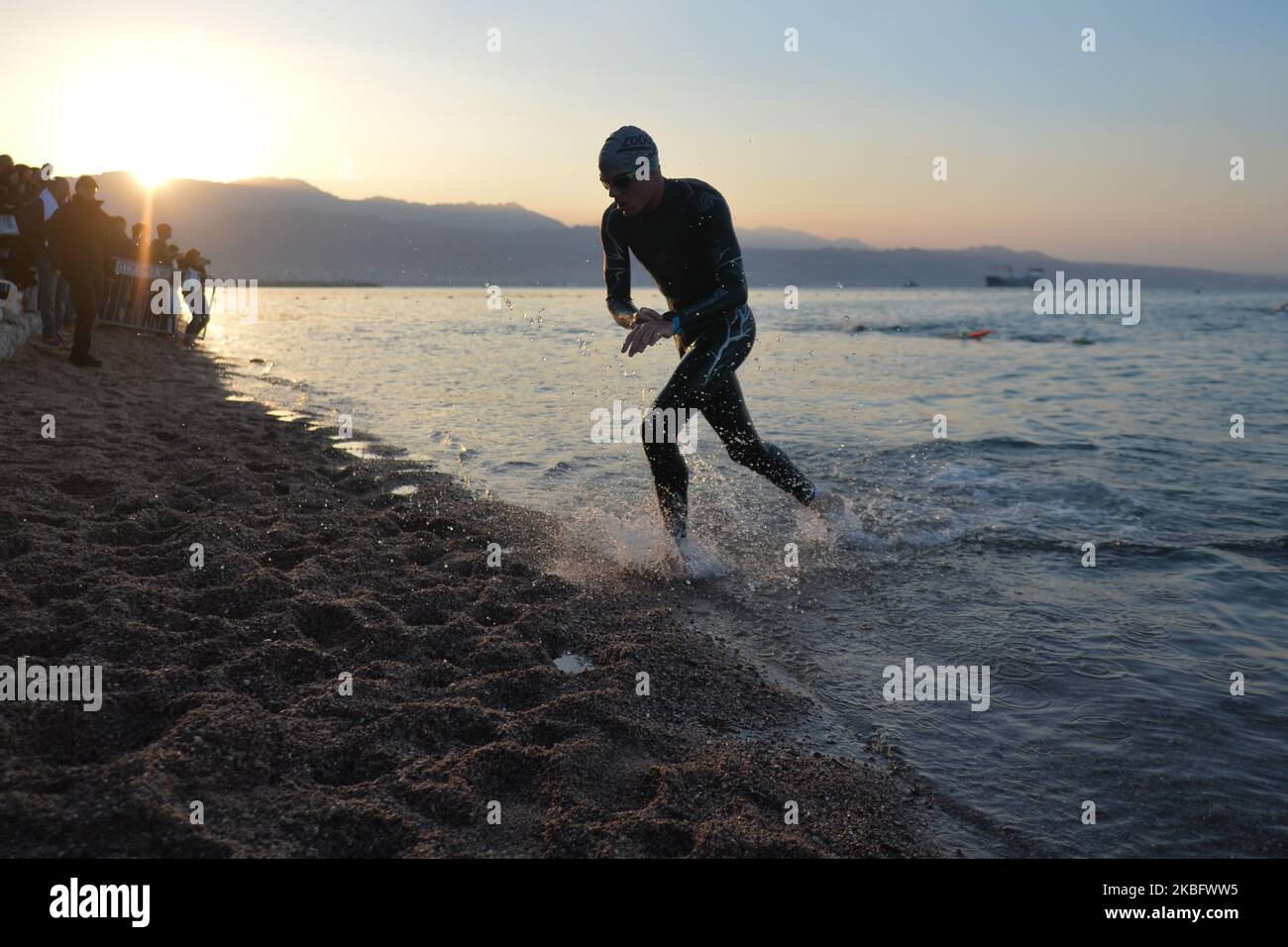 An athlete finishing his swim in the Red Sea during a full Ironman ...