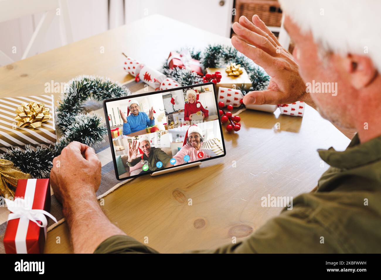 Caucasian man with santa hat having video call with happy diverse ...
