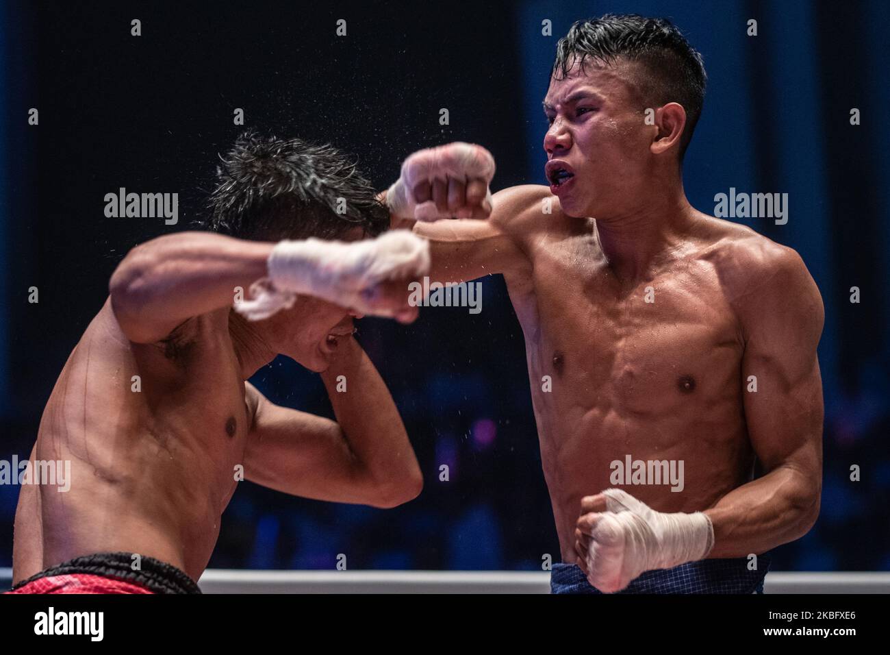 Lin Htet Naing of Myanmar (L) fights against Zin Bo of Myanmar (R) in their lightweight bout ...