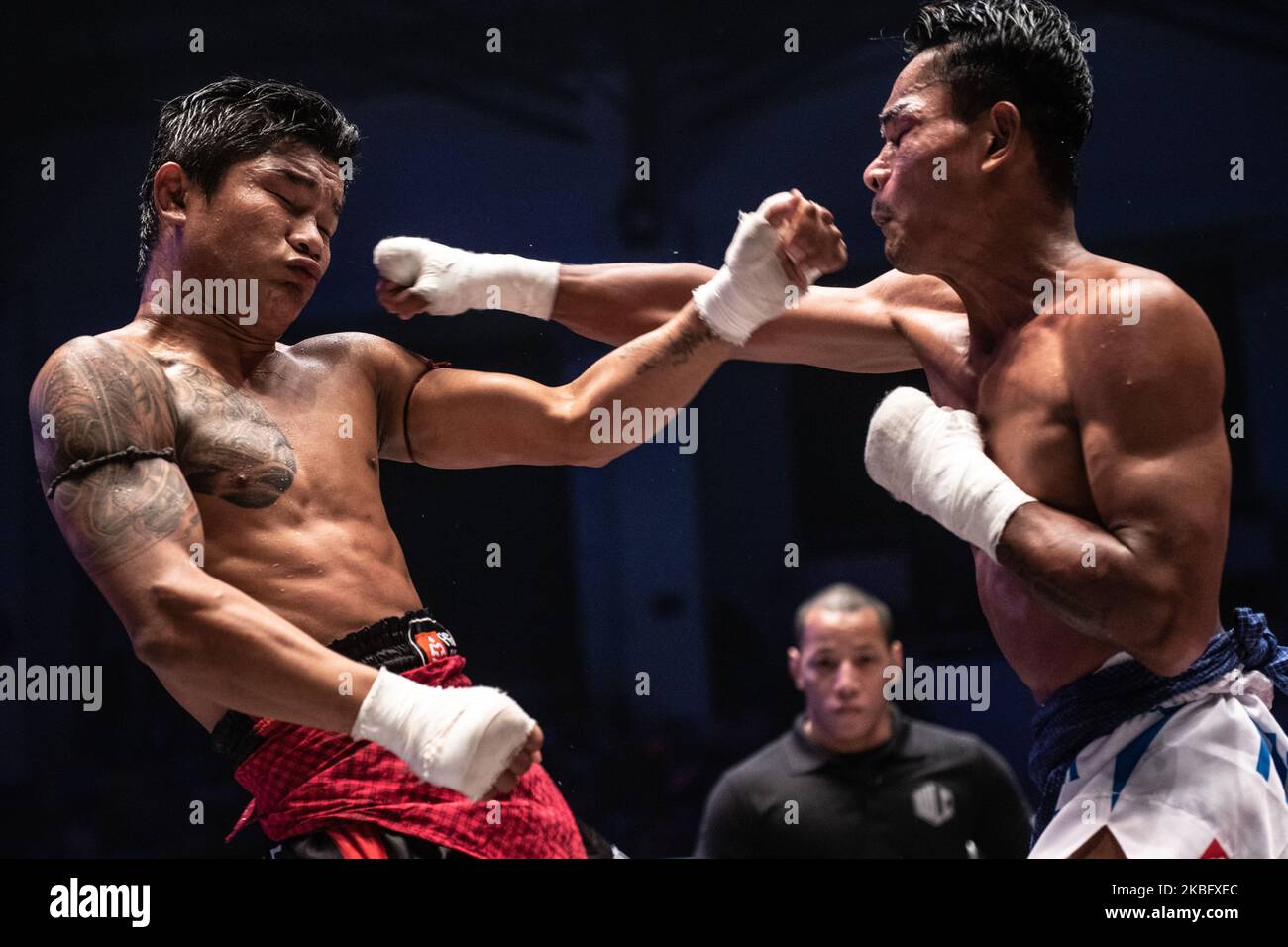 Em Sothy of Cambodia (R) punches Hein Tun Aung of Myanmar (L) in their lightweight bout during ...