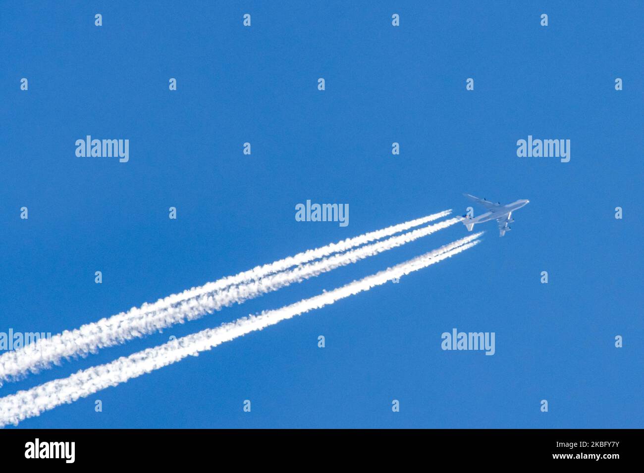 Lufthansa Boeing 747 commercial airplane overfly forming engine exhaust ...