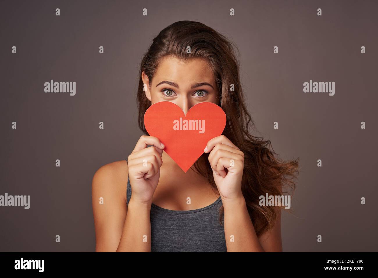 Can I hold your heart forever. Studio shot of an attractive young woman ...