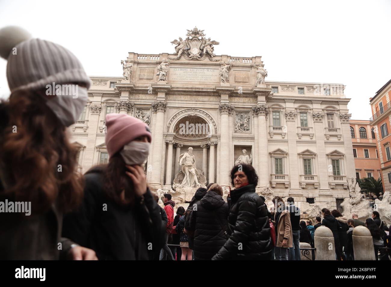 A tourist wearing a protective respiratory mask tours outside the ...