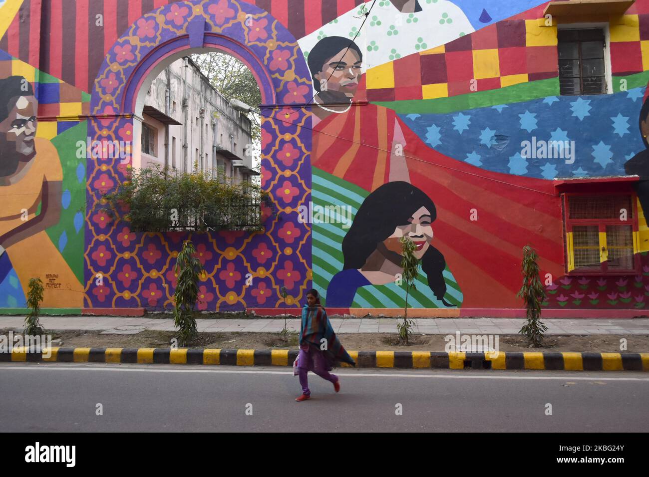 An Indian women walks past a mural in Lodhi Colony, New Delhi on 01 ...