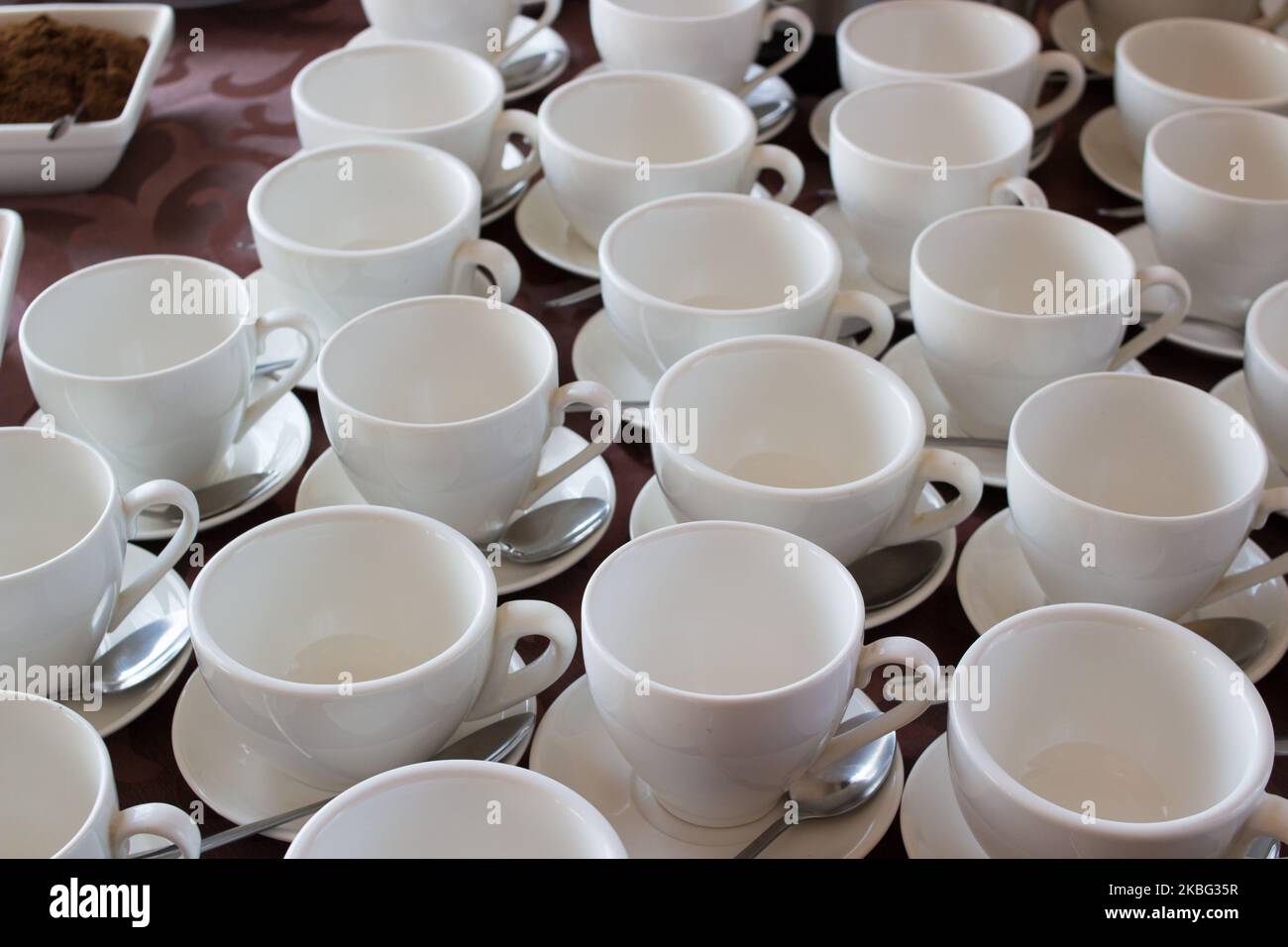 many white cups empty clean to table Stock Photo - Alamy