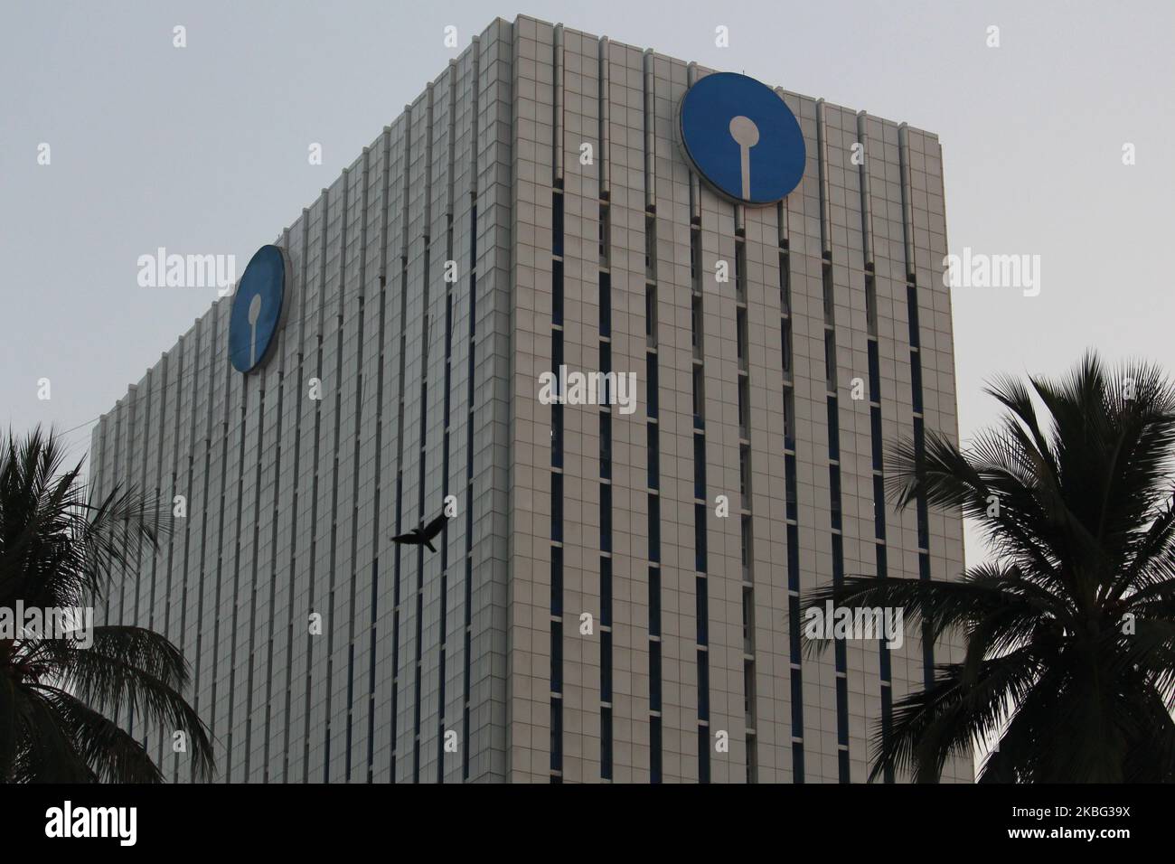 A bird flies past the State Bank of India (SBI) building in Mumbai ...