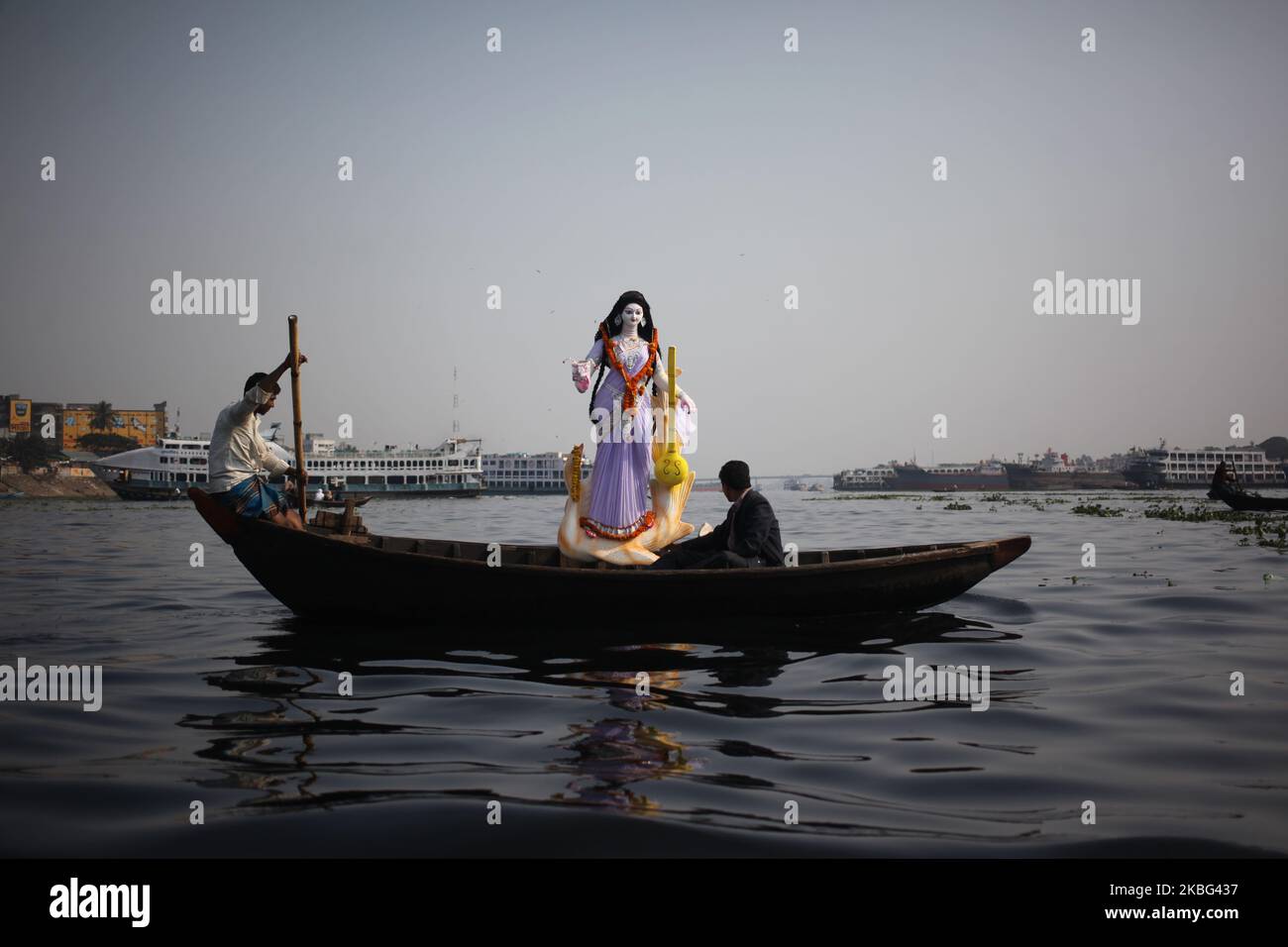 A Hindu devotee brings an idol of Goddess Saraswati to immerse in the ...