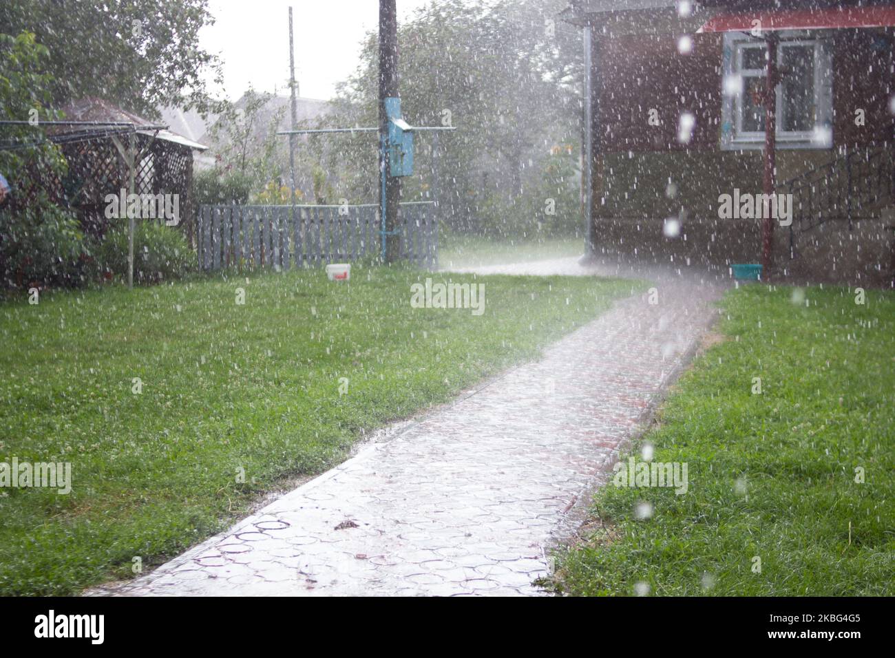 Rain falls in the courtyard of our house Stock Photo - Alamy
