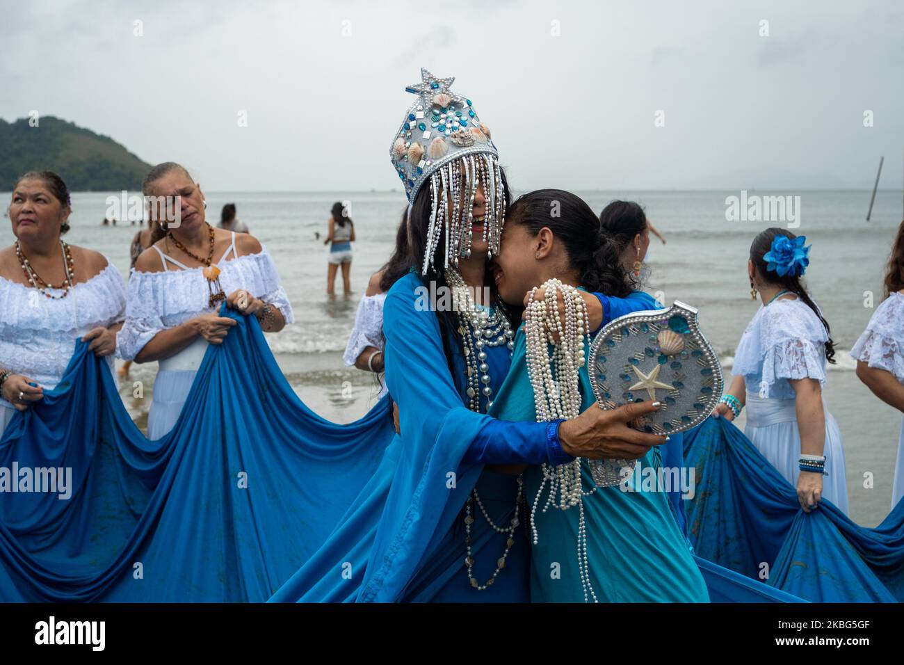 A devotee of the Afro-Brazilian goddess of the sea embraces and cries a ...