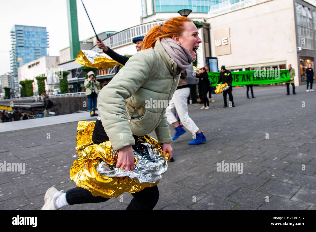 A group of XR activists are running in panic while the siren alarm is ...
