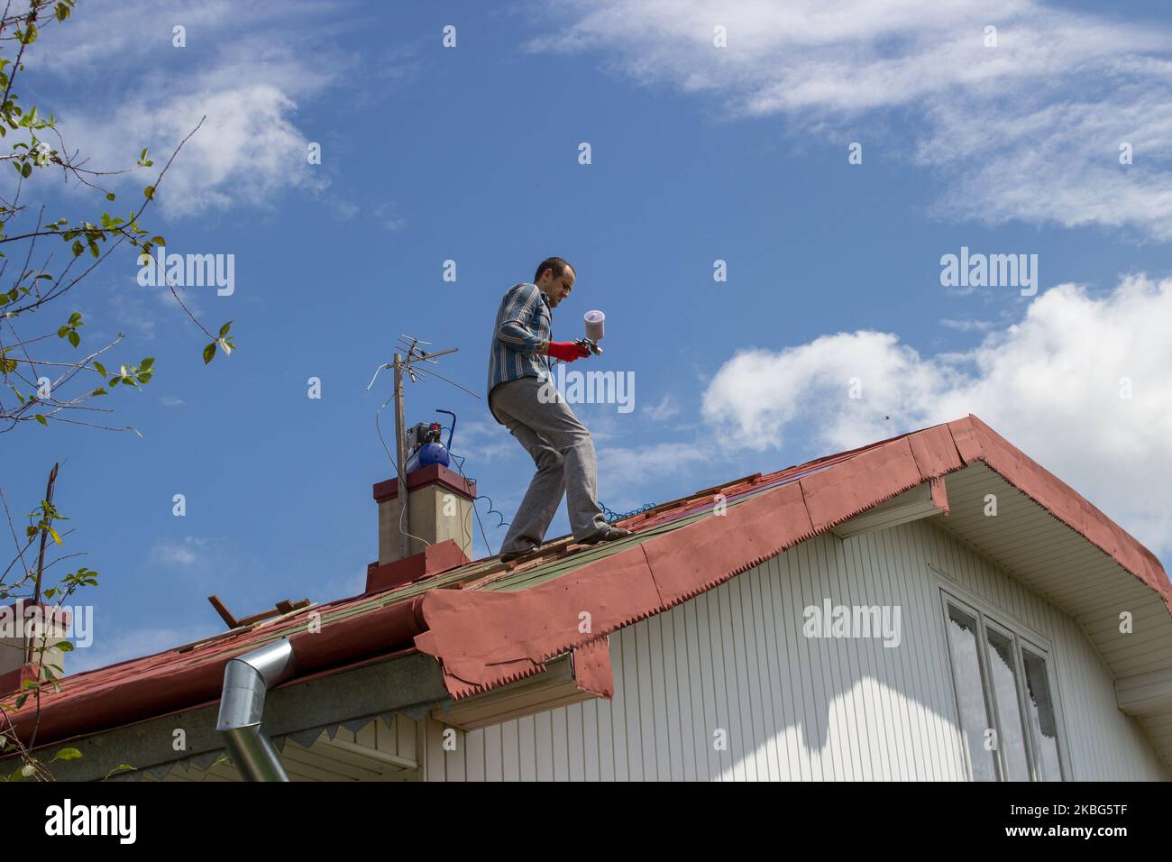 Person on roof hi-res stock photography and images - Alamy
