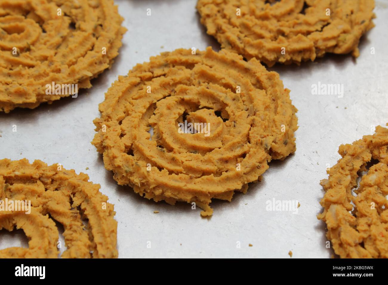 Raw chakali in plate. Indian Traditional Tea Time Snack Chakli, a deep ...