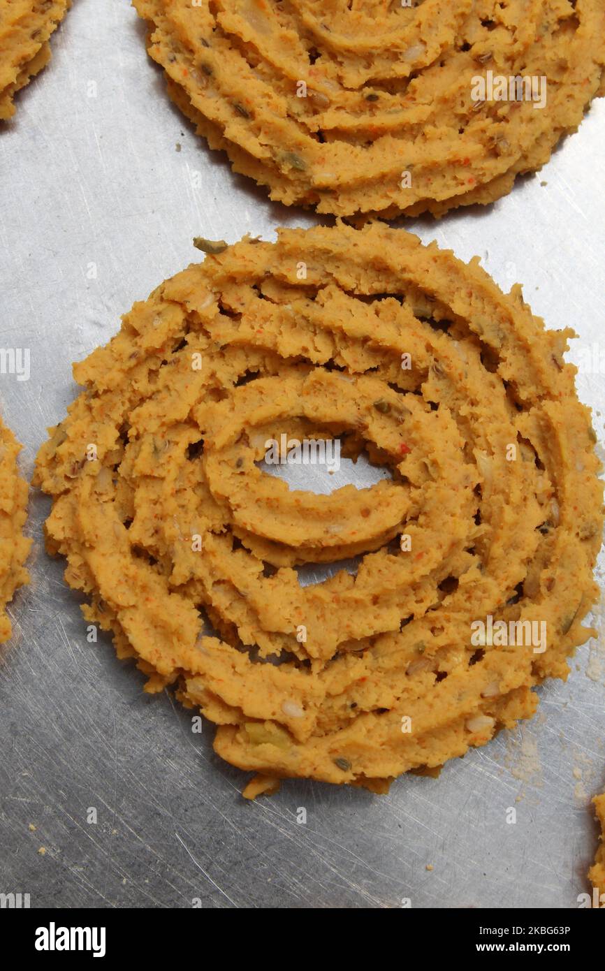Raw chakali in plate. Indian Traditional Tea Time Snack Chakli, a deep ...