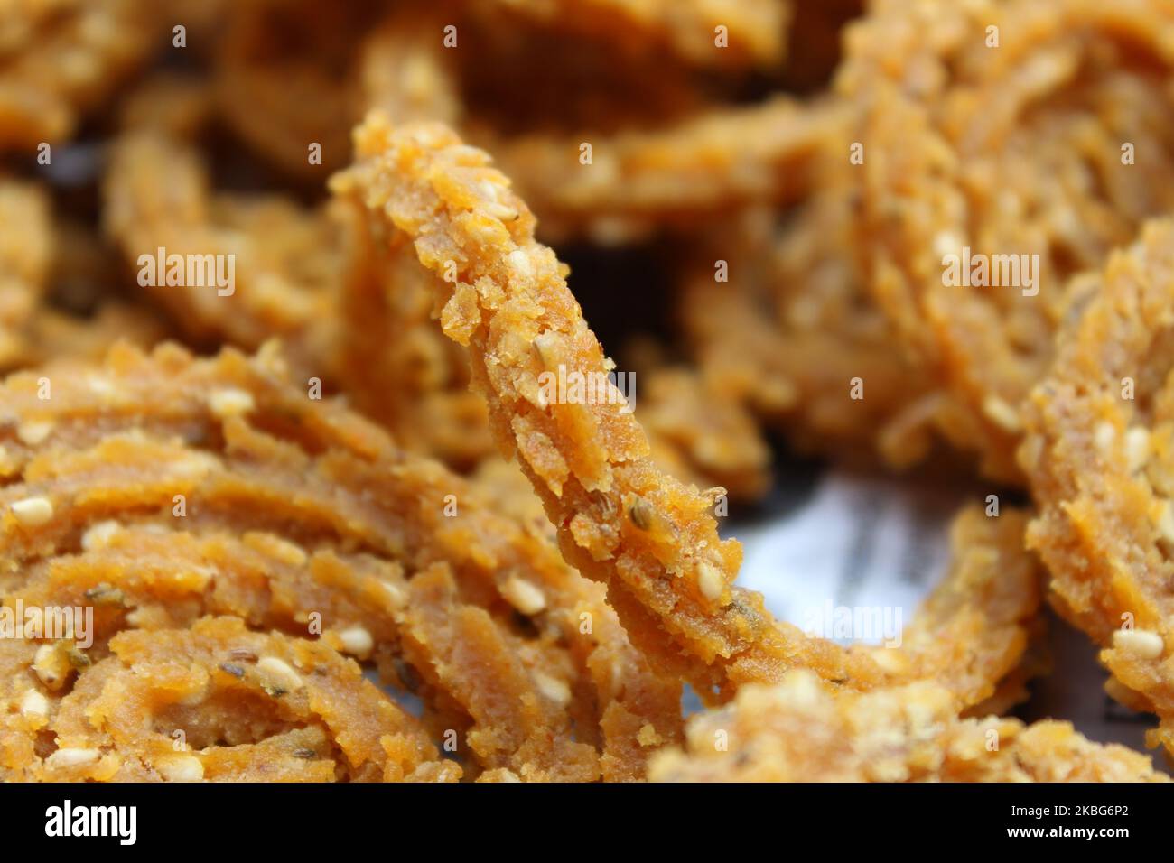 Raw chakali in plate. Indian Traditional Tea Time Snack Chakli, a deep ...
