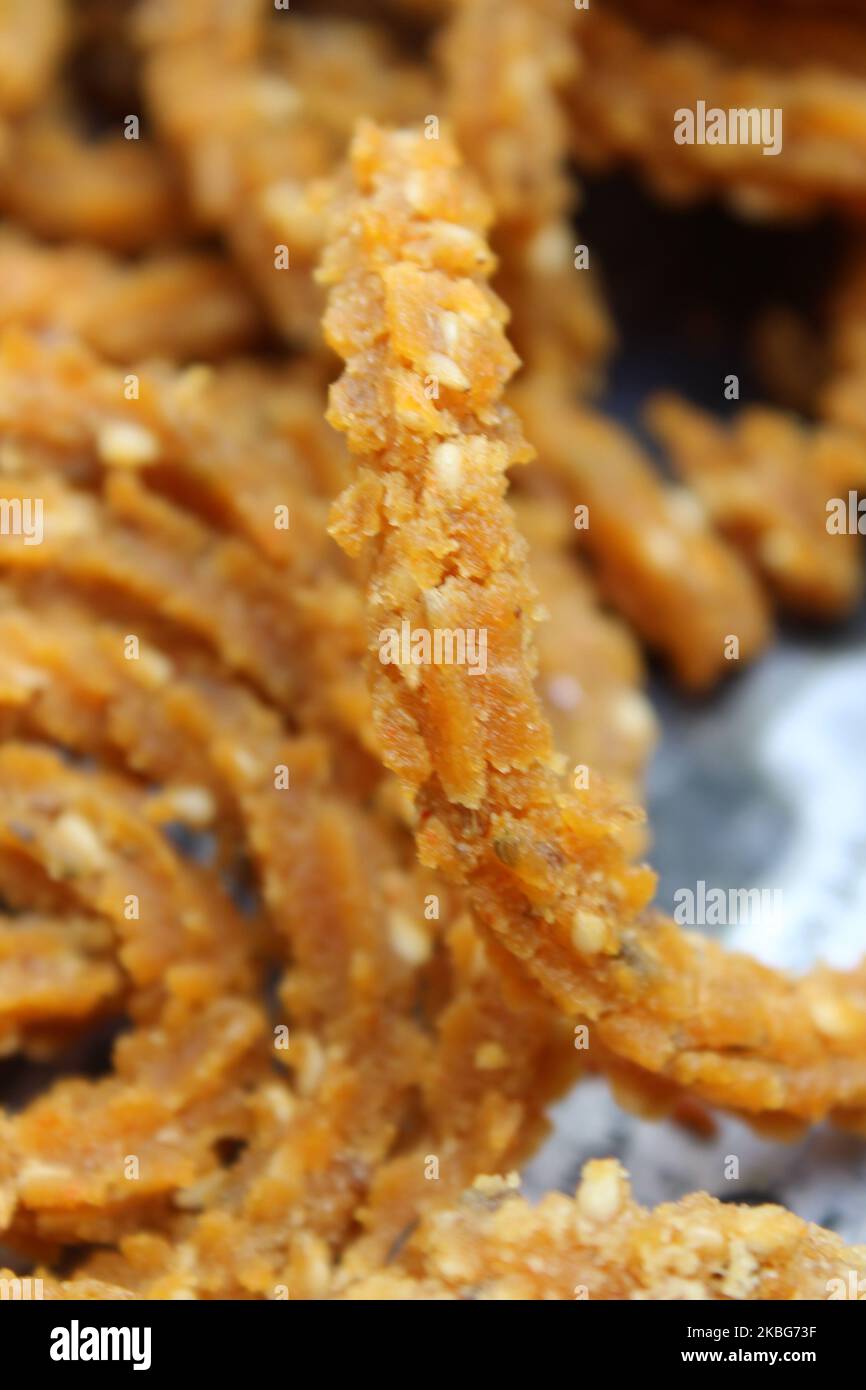 Raw chakali in plate. Indian Traditional Tea Time Snack Chakli, a deep ...
