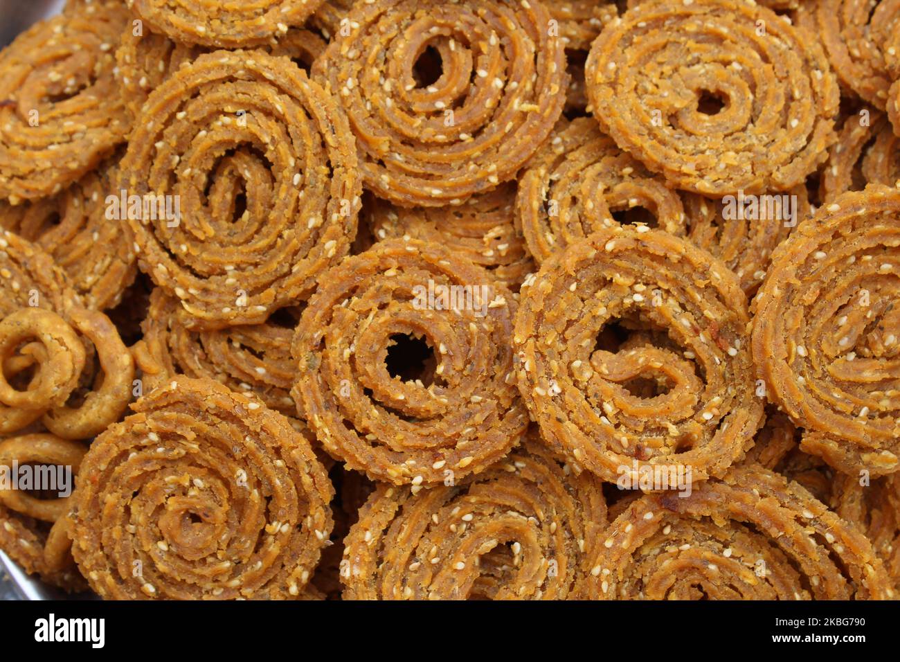 Raw chakali in plate. Indian Traditional Tea Time Snack Chakli, a deep ...