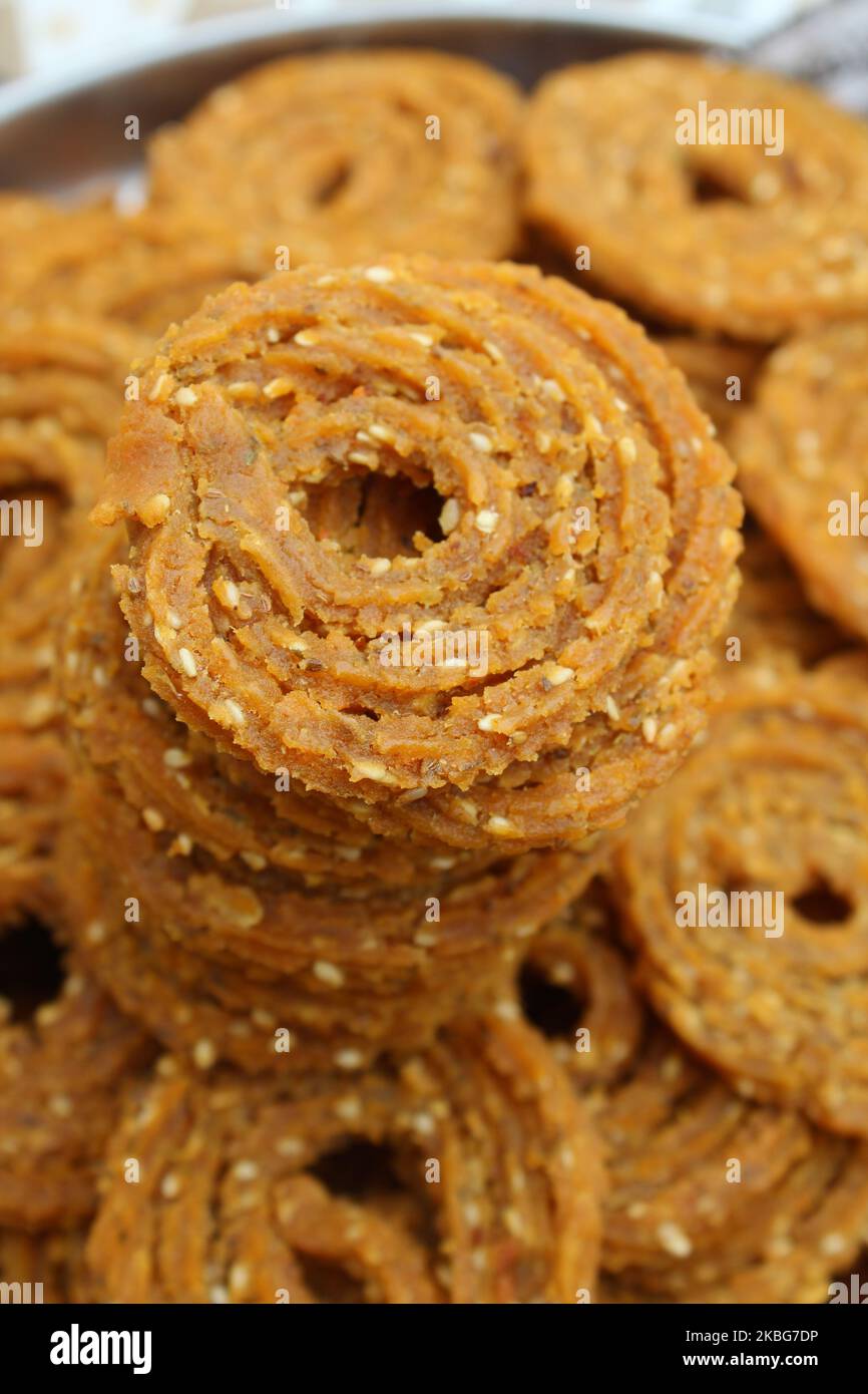 Raw chakali in plate. Indian Traditional Tea Time Snack Chakli, a deep ...