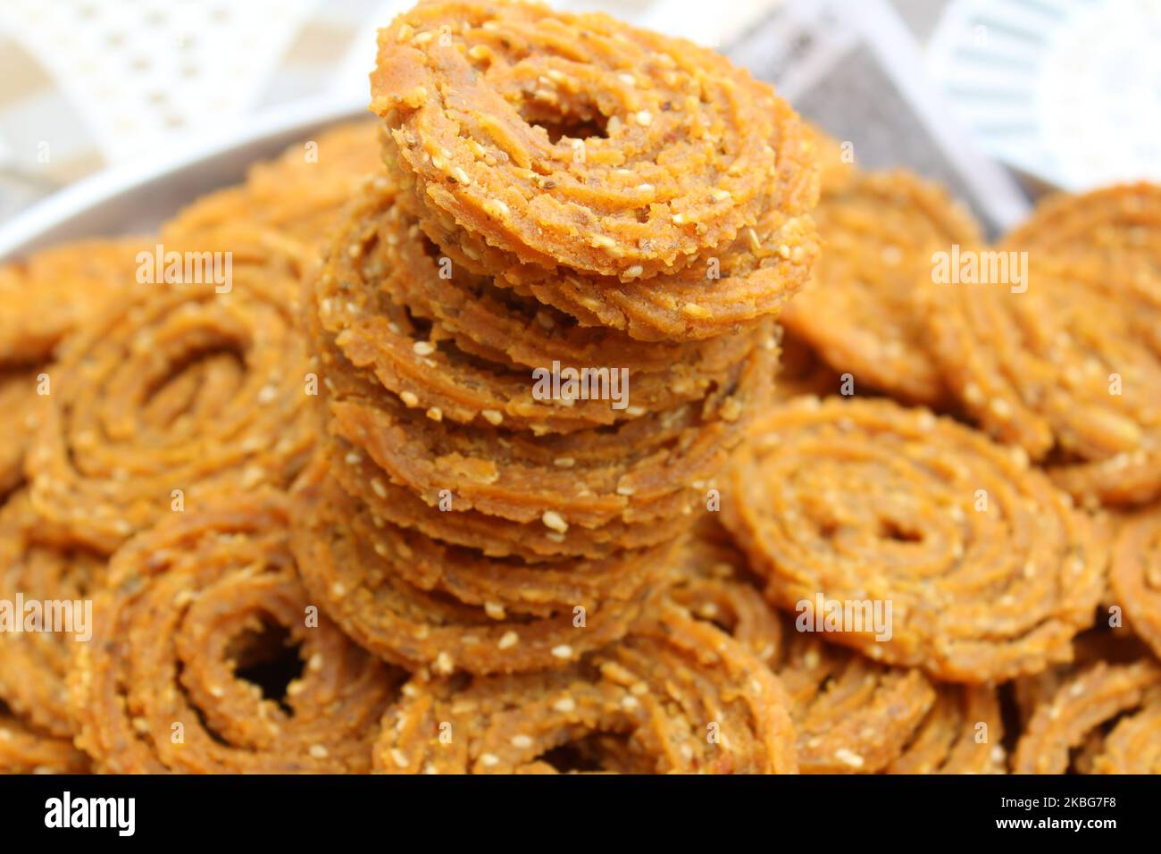 Raw chakali in plate. Indian Traditional Tea Time Snack Chakli, a deep ...