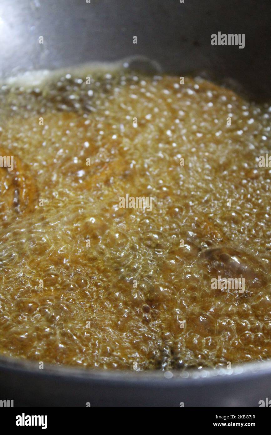 Chakali frying in oil, Indian Traditional Tea Time Snack Chakli, a deep ...