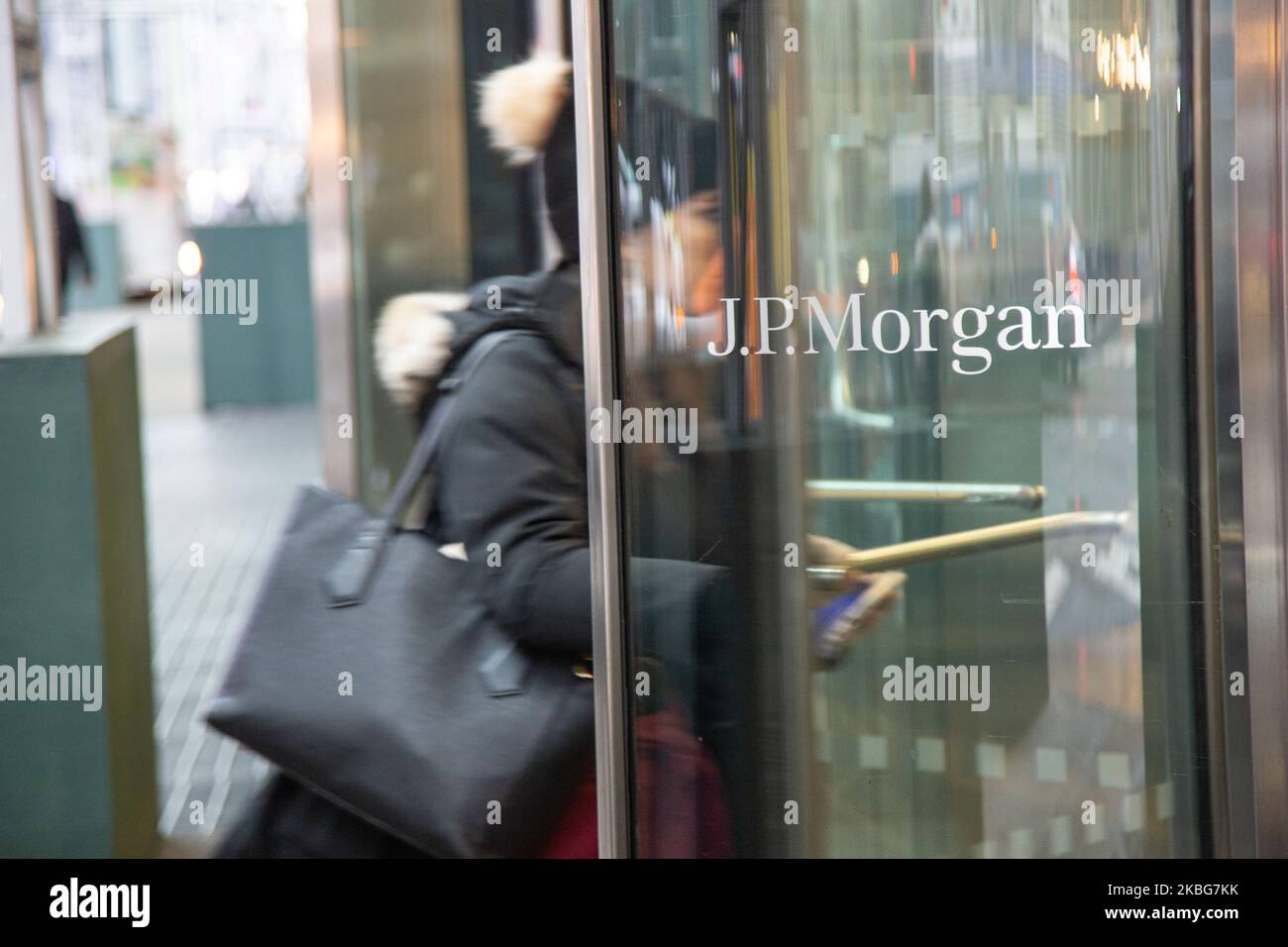 The J.P. Morgan logo sign on the entrance of a glass office building in ...