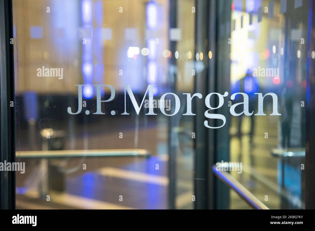 The J.P. Morgan logo sign on the entrance of a glass office building in ...