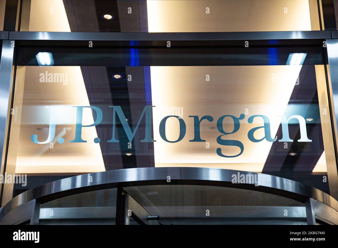 The J.P. Morgan logo sign on the entrance of a glass office building in ...