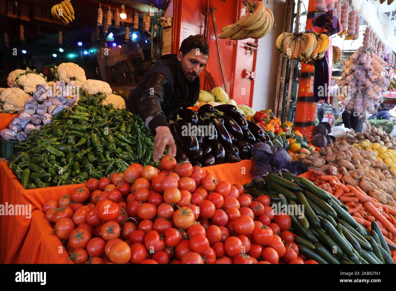 A Palestinian youth sells vegetables at the market in Gaza City on ...