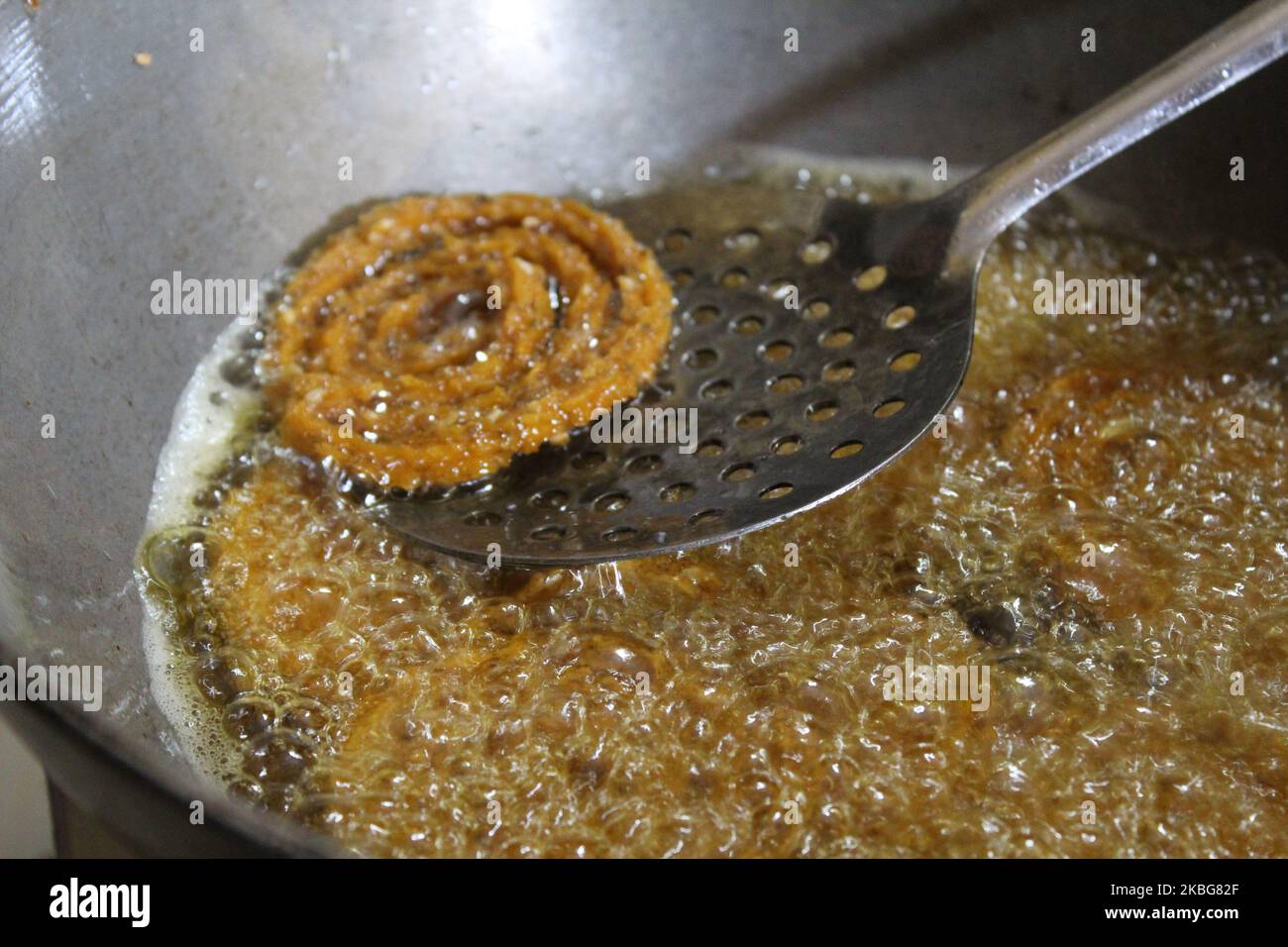 Chakali frying in oil, Indian Traditional Tea Time Snack Chakli, a deep ...