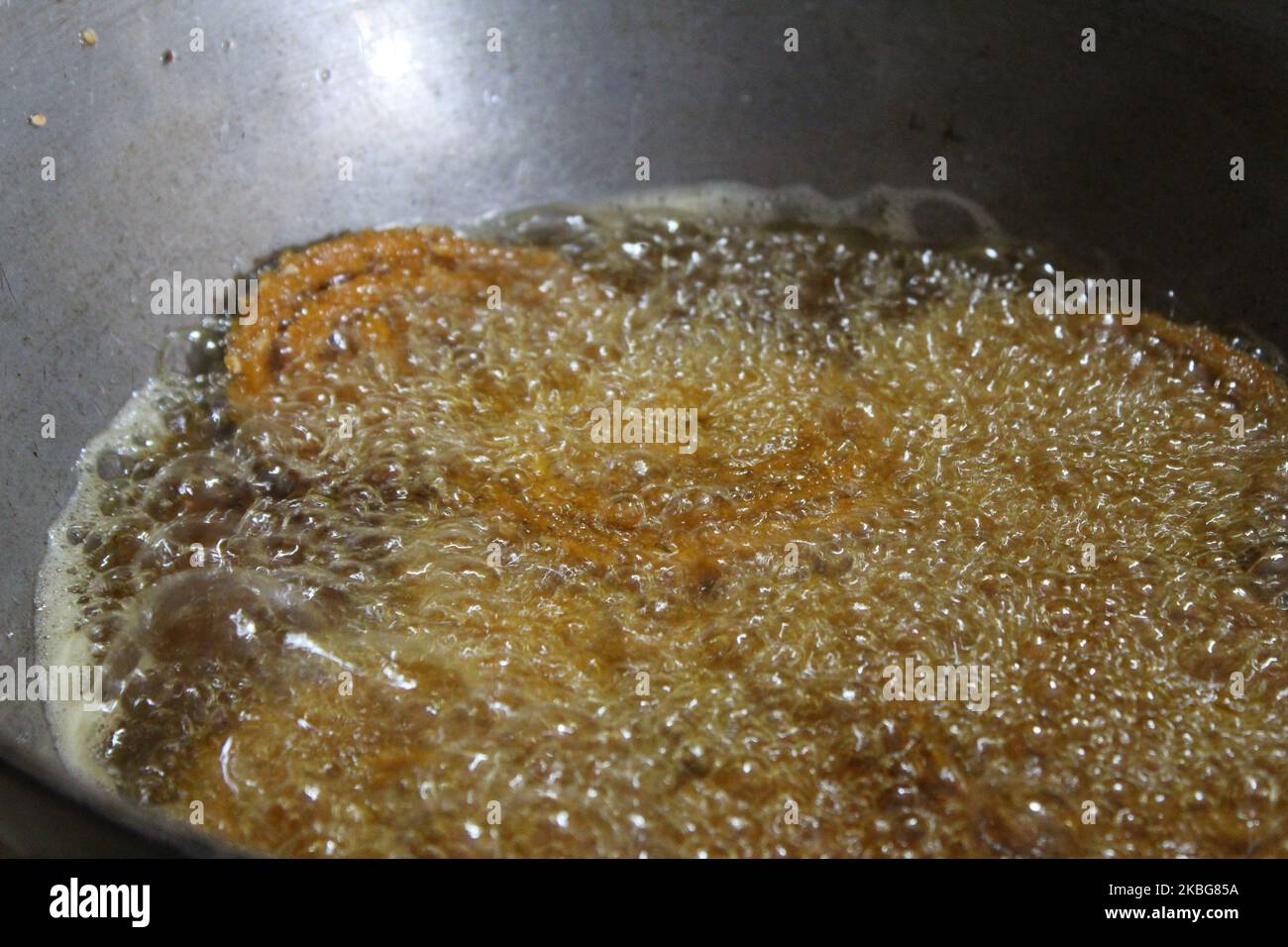 Chakali frying in oil, Indian Traditional Tea Time Snack Chakli, a deep ...