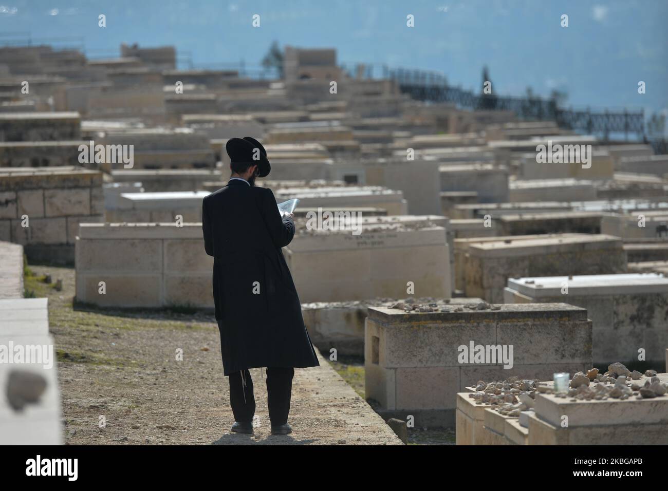 A visitor in the Jewish cemetery, the Mount of Olives, Jerusalem. On ...