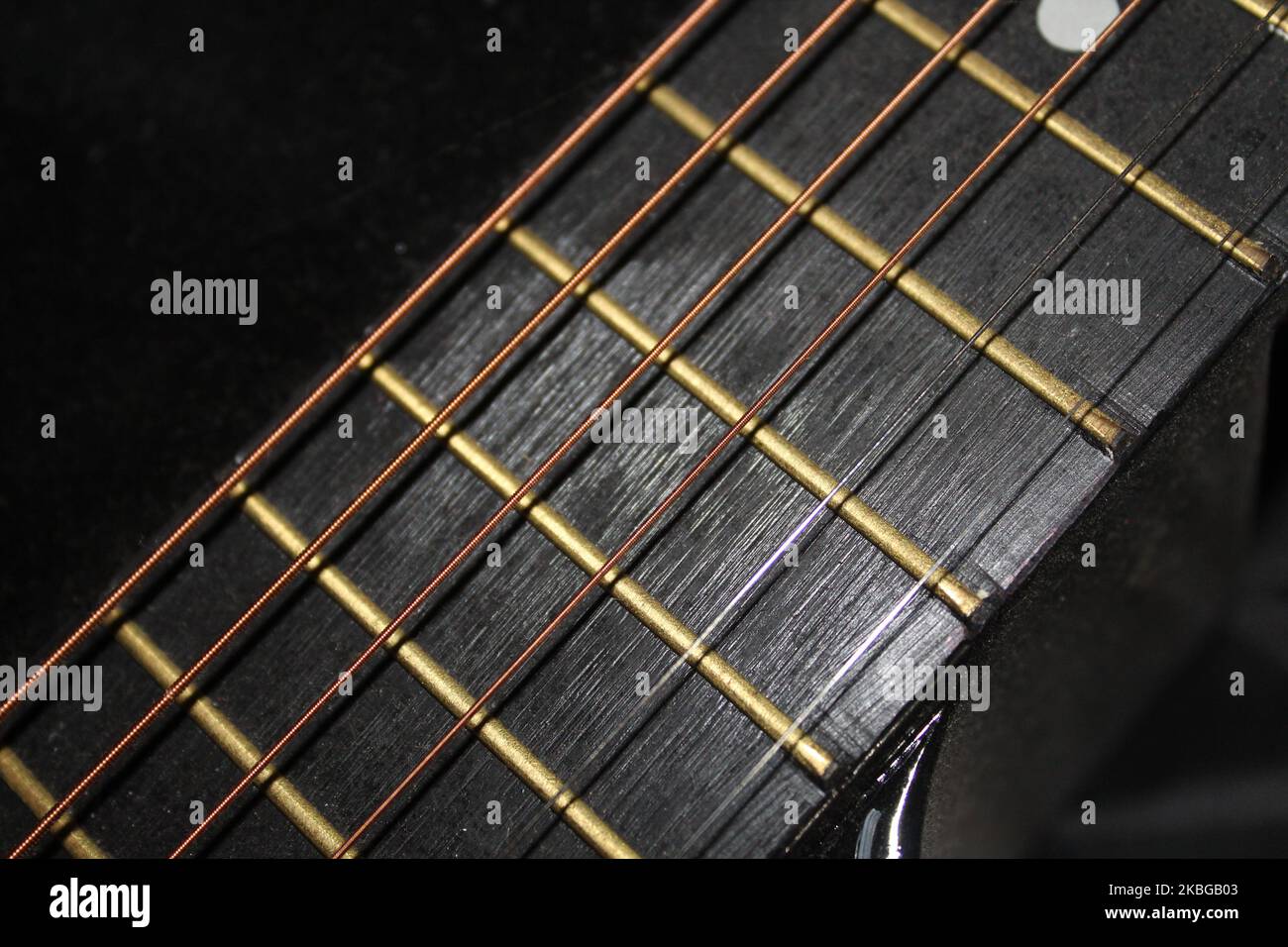 Strings of guitar with black freats Stock Photo - Alamy