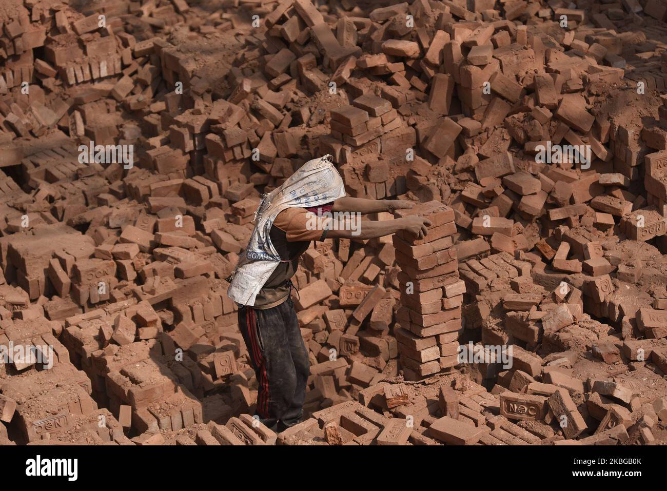Migrant indian labourer stacks bricks hi-res stock photography and ...