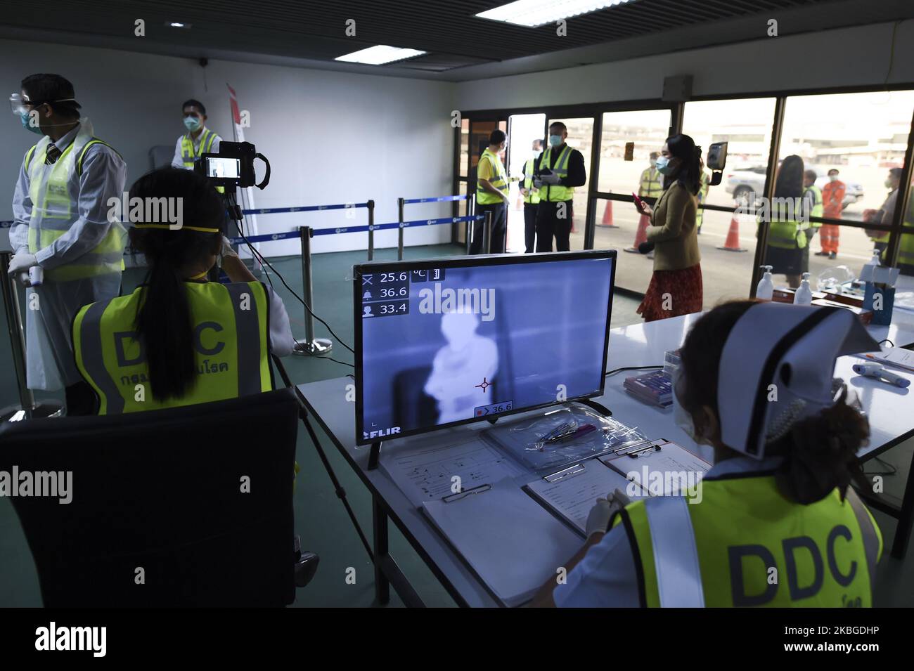 An official prepare a thermal scanner camera to check the body ...