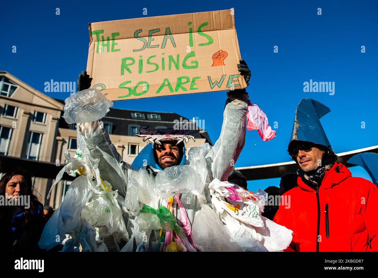A man is wearing plastic bags and a crab mask, during the School Strike ...