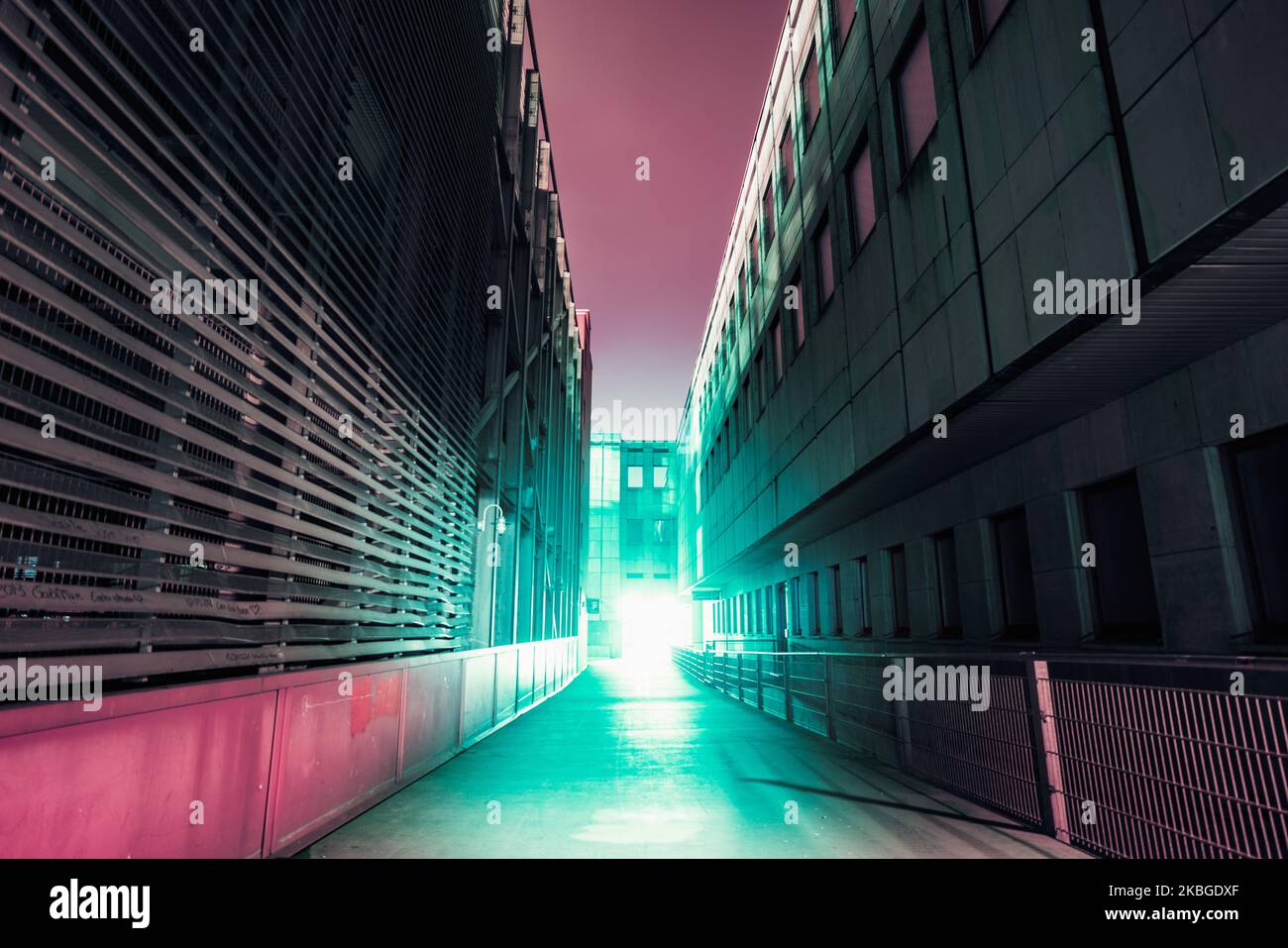 Narrow street of the night city with light driving towards the car ...