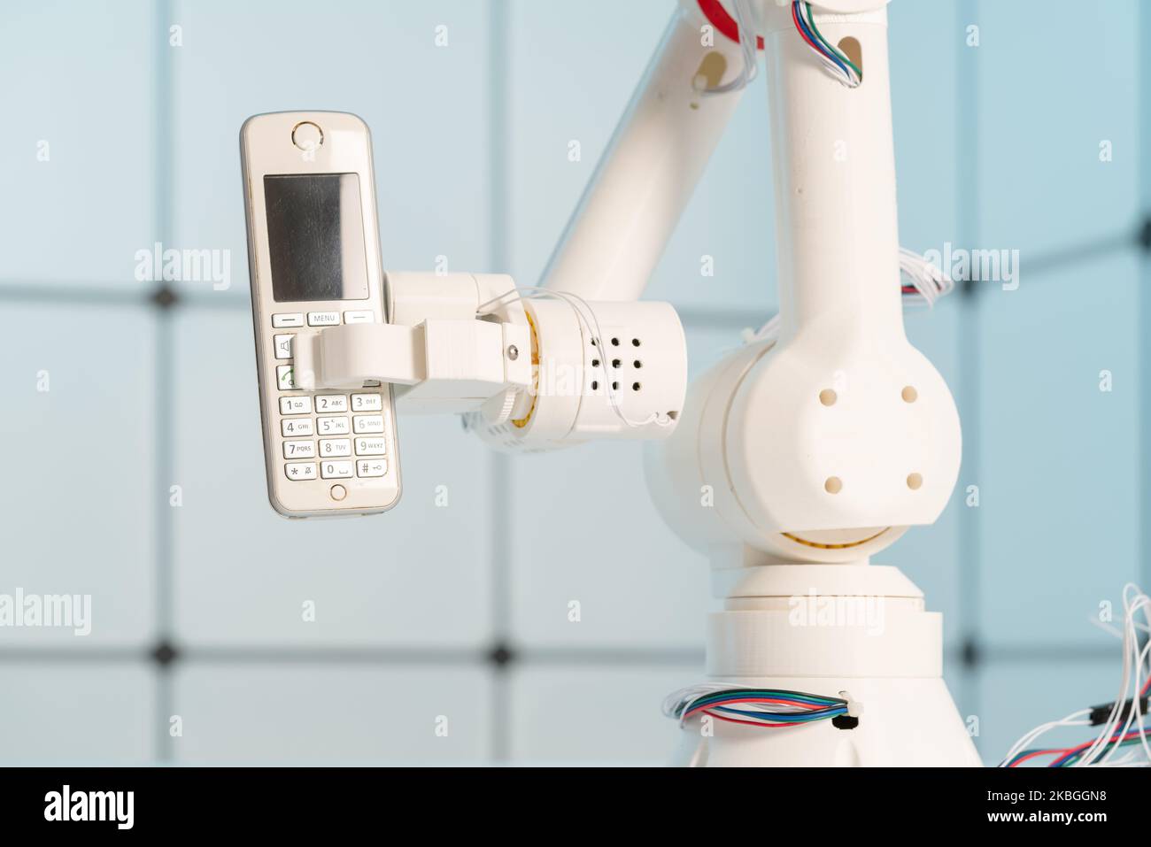 Phone in robot arm, bot concept on customer support hotline. Using ...