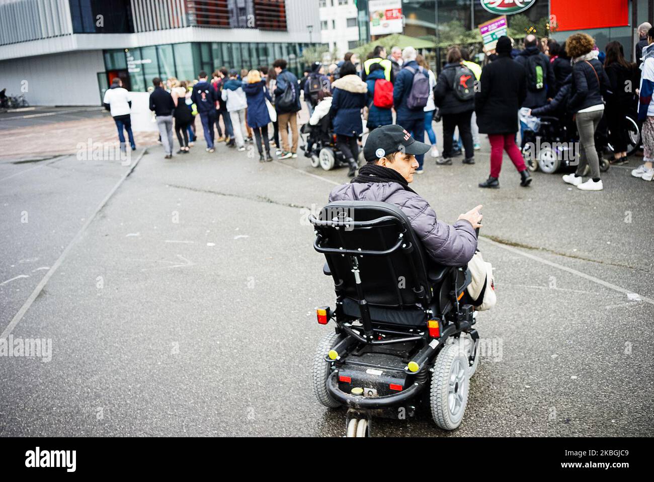 A person in a wheelchair demonstrates for greater inclusion of people ...