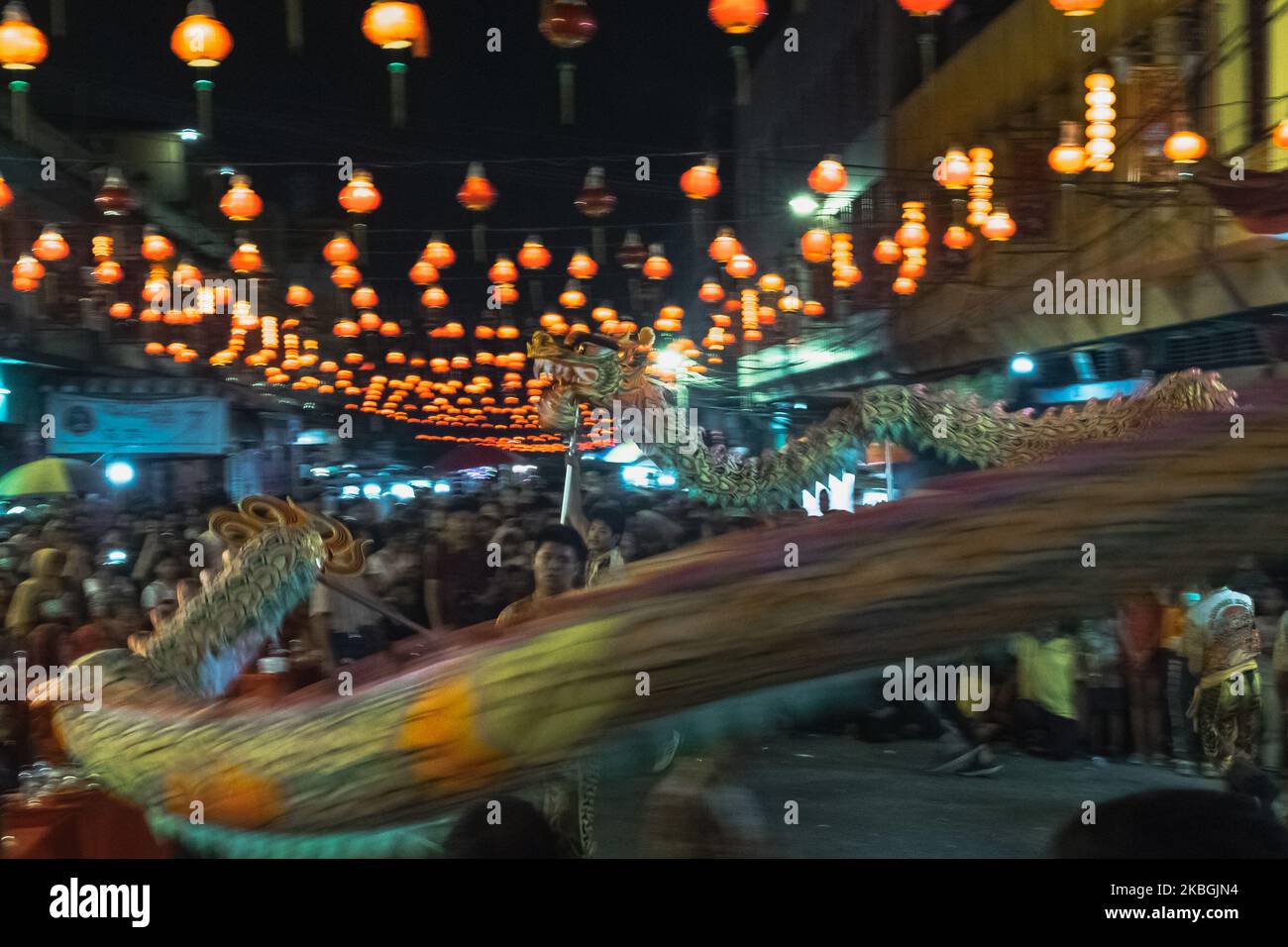 People perform dragon dance during a Cap Go Meh Festival celebration ...