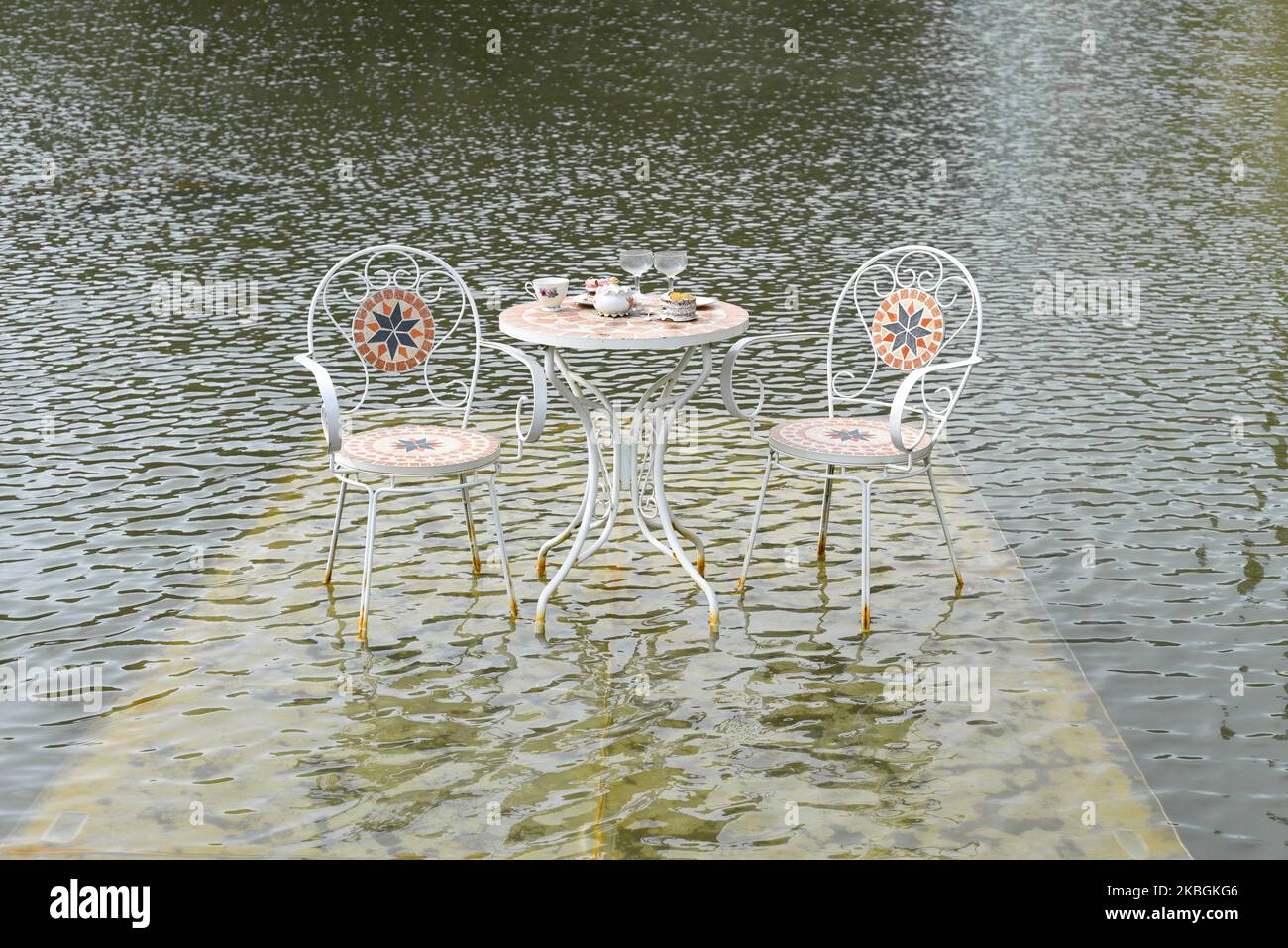Chairs and coffee table with tea cups and glasses in water in Da Lat ...