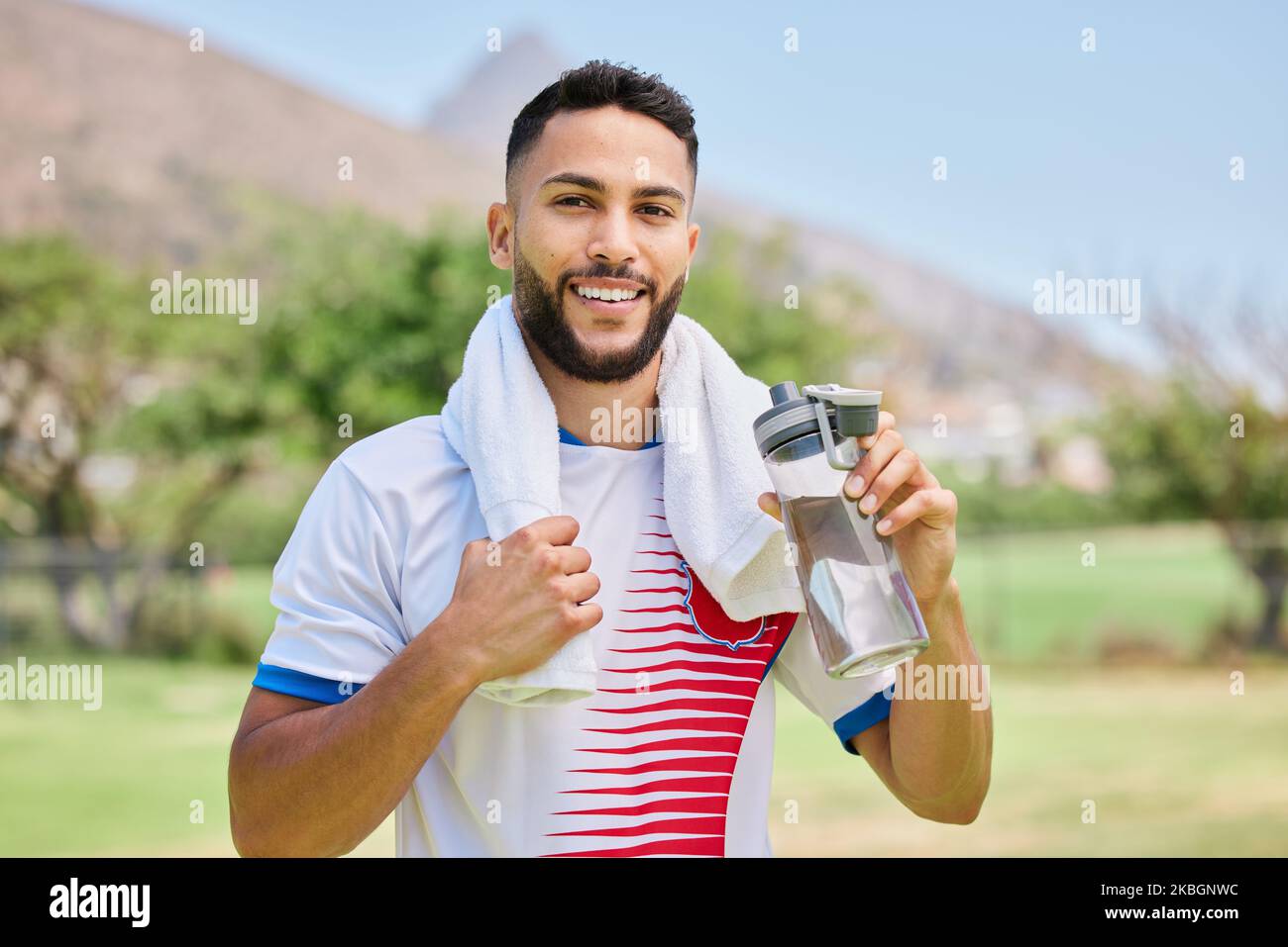 Portrait, fitness and soccer player drinking water in training, cardio ...