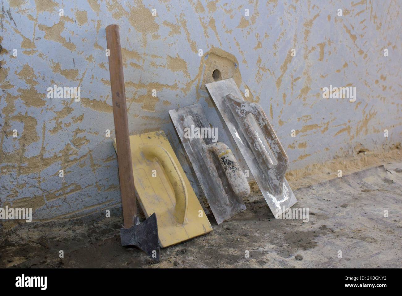 Construction tools trowel plastering the wall in the room Stock Photo ...