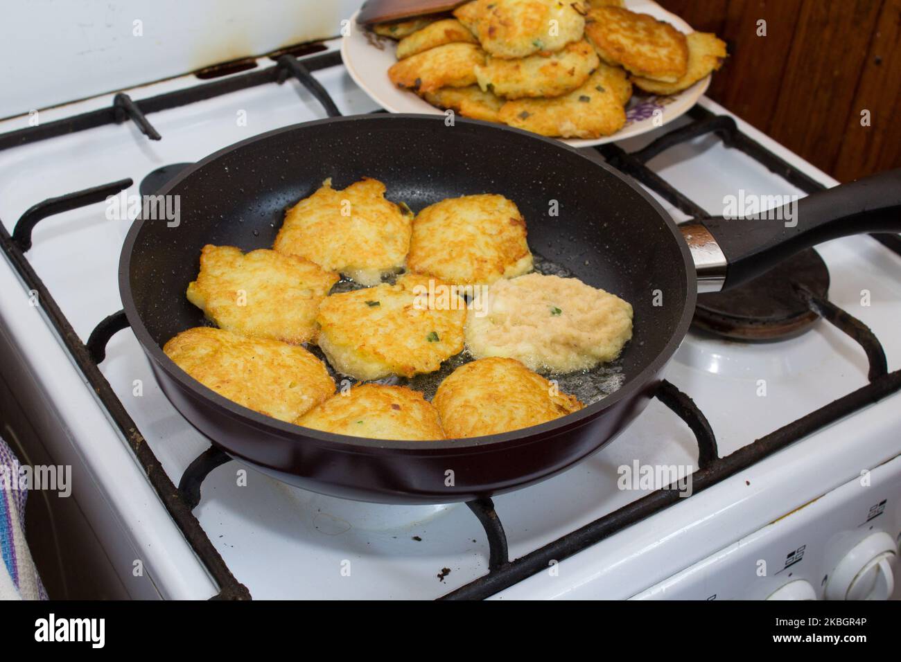 fried potato pancakes on a hot pan on a gas stove Stock Photo - Alamy