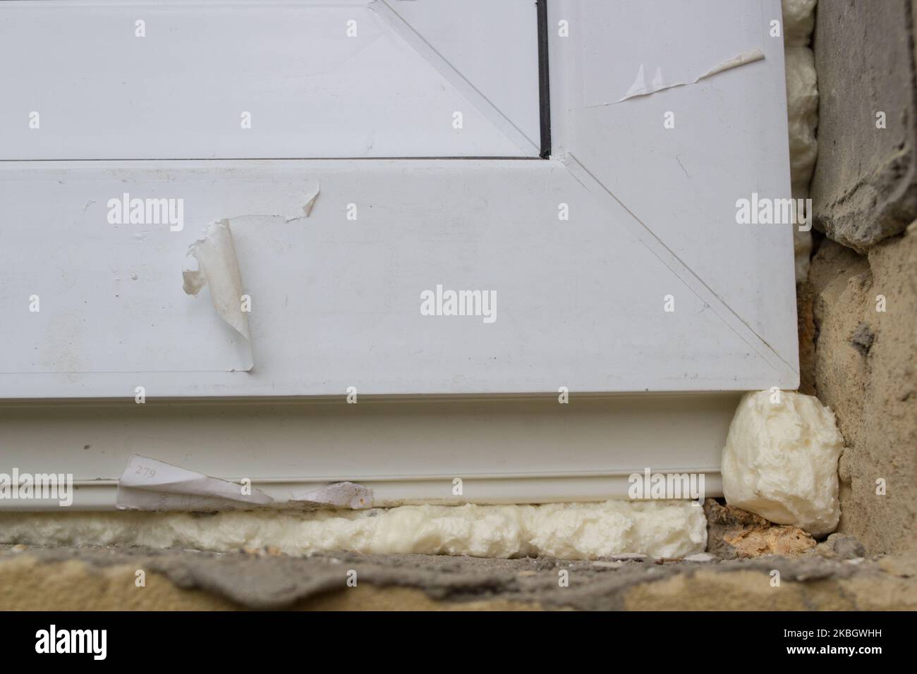 Frame of a white plastic window fastened with foam mounting Stock Photo ...