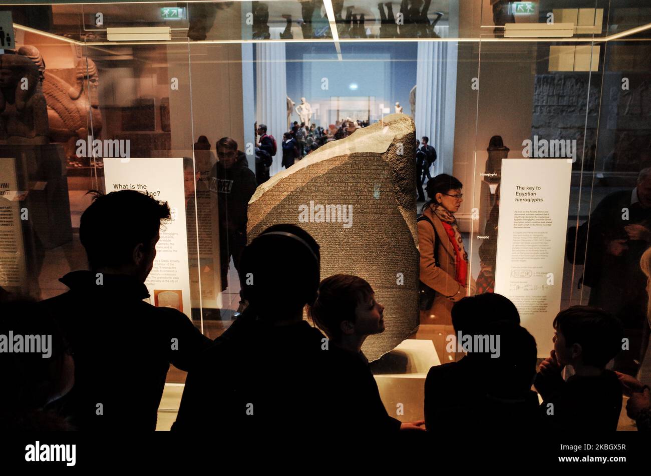 Visitors view the Rosetta Stone in the ancient Egypt section of the ...