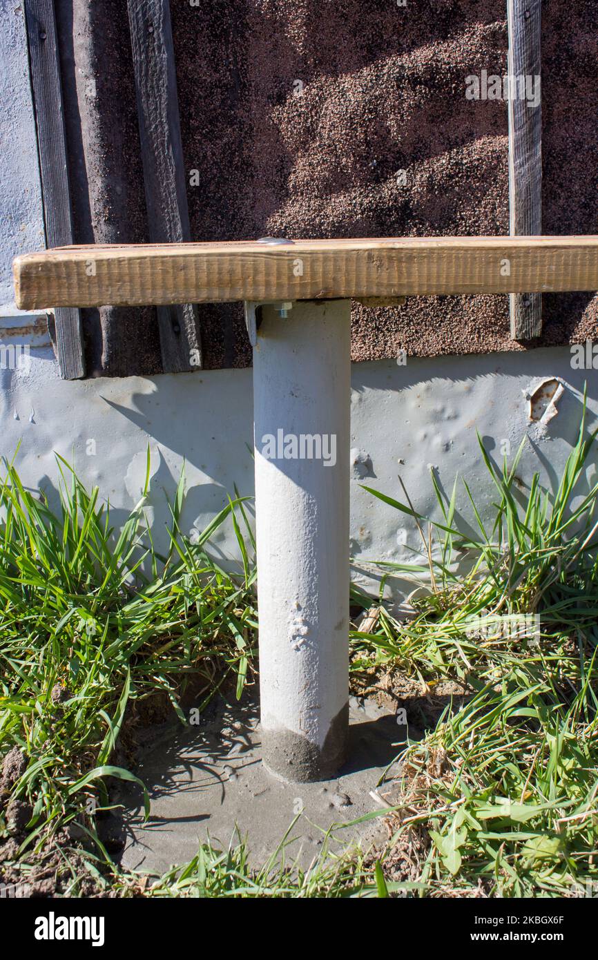 Column metal benches concreted into the ground Stock Photo - Alamy