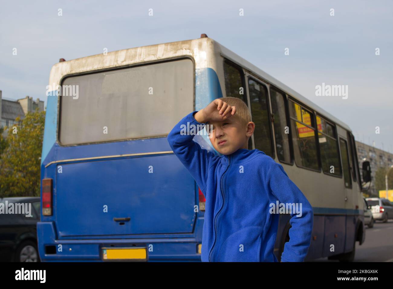 on the roadside the boy looks like his bus Stock Photo - Alamy